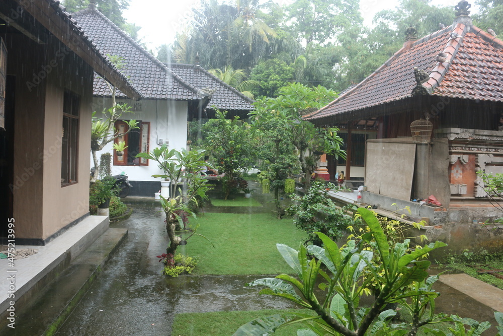 the yard of the house that looks wet due to heavy rain so it looks like ...