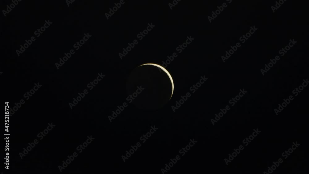 Still video of thin moon slowly moving in dark night sky. Perfect night ...