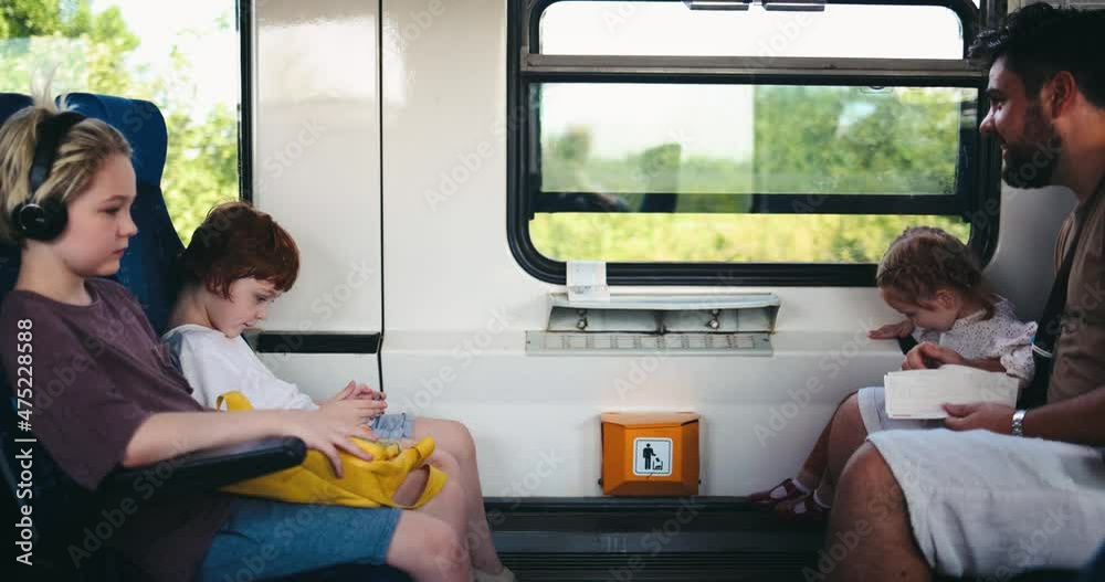 family with kids travelling by suburban train. using public transport ...
