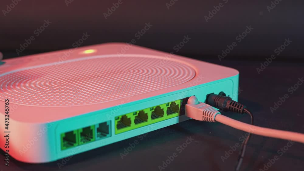 Shot showing the ethernet cable on the back of the internet router. A ...