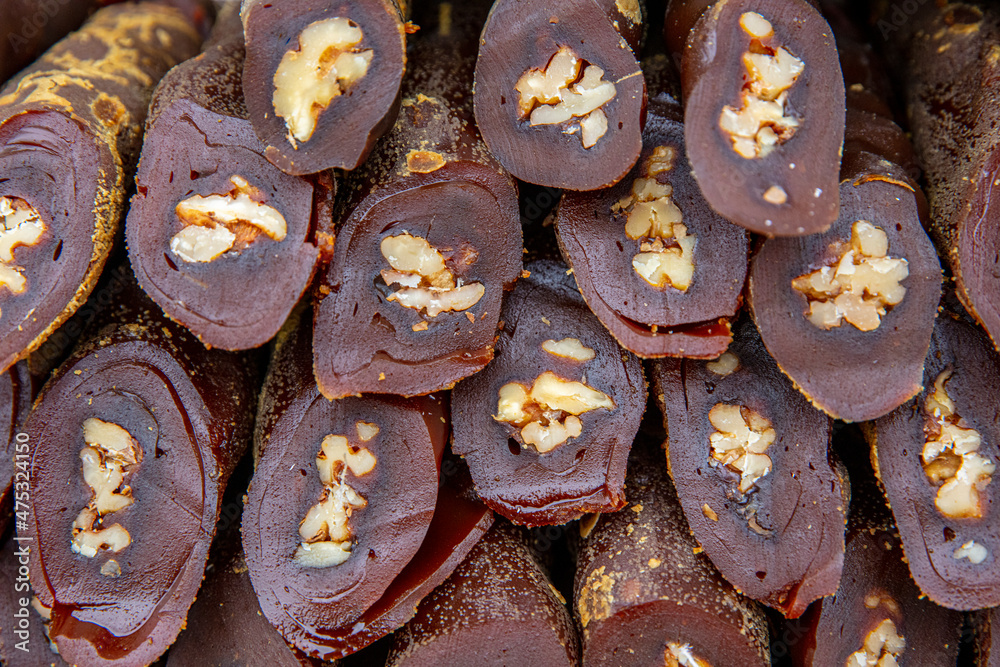 Cevizli sucuk made by dipping a string with walnuts into a grape ...