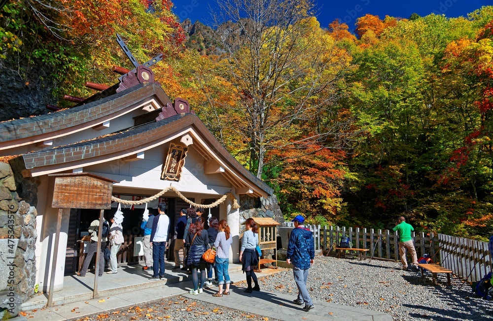 Tourists lining up to worship in the shrine of Togakushi Jinja, a ...