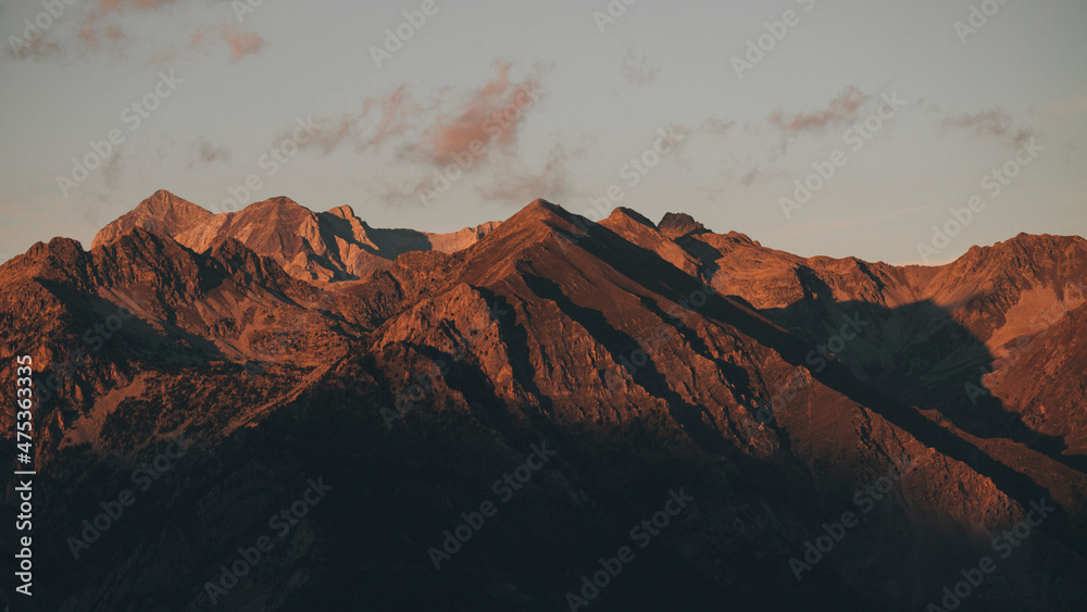High mountains alpenglow orange color during sunset in the Pyrenees ...