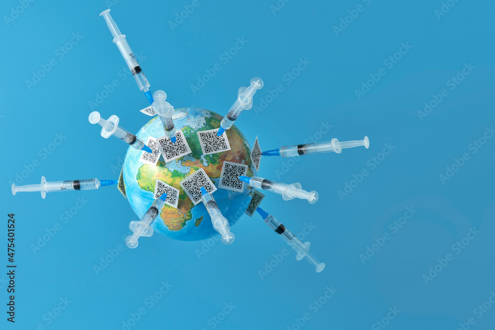 A globe on a light blue background with a lot of syringes with a ...