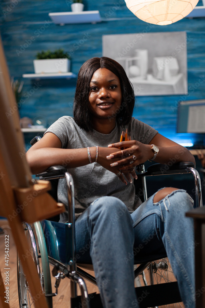 Portrait of illustrator artist in wheelchair working at creative ...