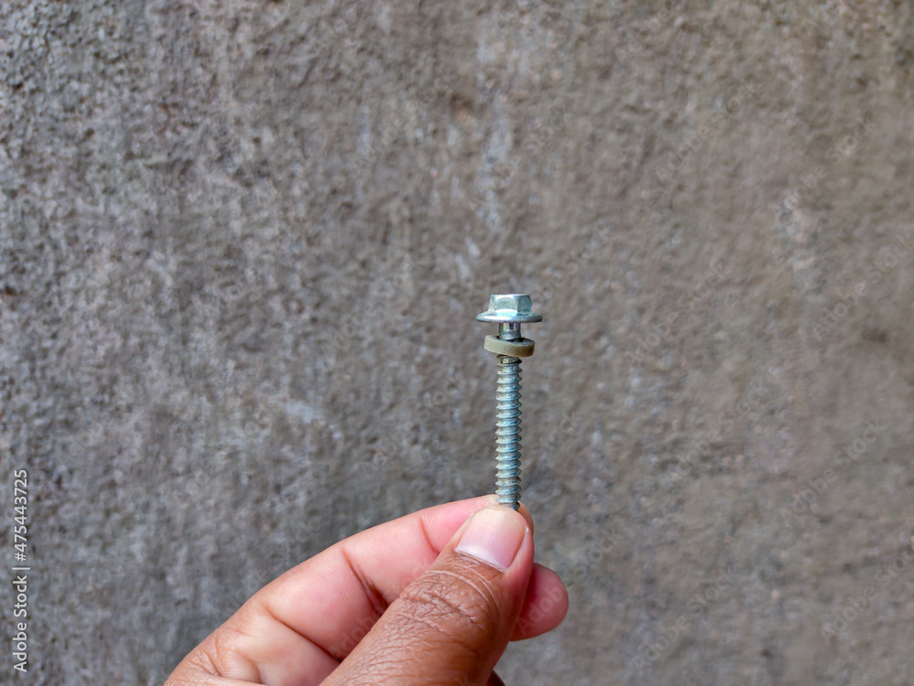 Hand holding Self tapping screws Stock Photo | Adobe Stock