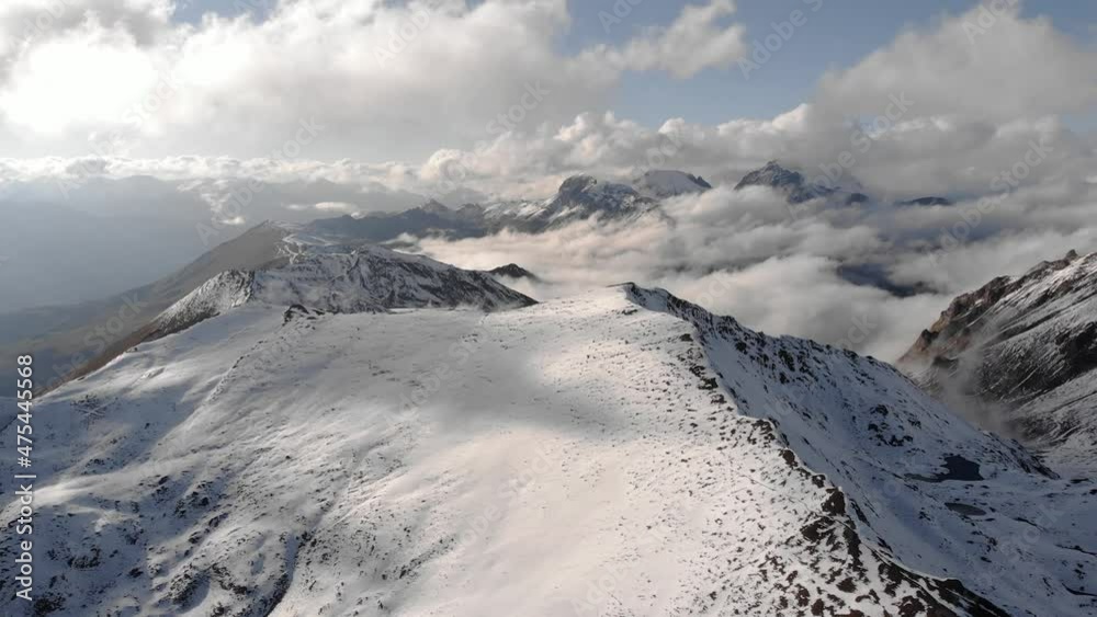Snow-capped mountains in the clouds, bird's-eye view. Far north ...