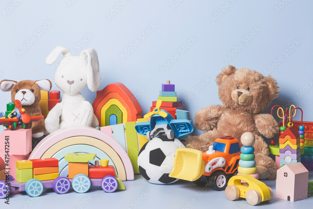 Kid toys collection isolated on blue background. Teddy bear, wooden ...