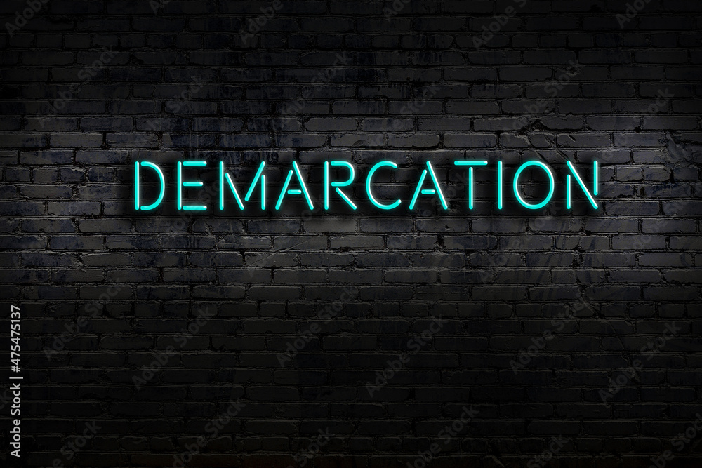 Neon sign. Word demarcation against brick wall. Night view Stock ...