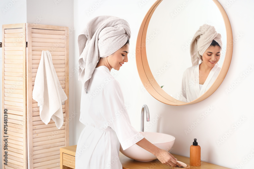 Beautiful young woman washing hands in bathroom Stock Photo | Adobe Stock
