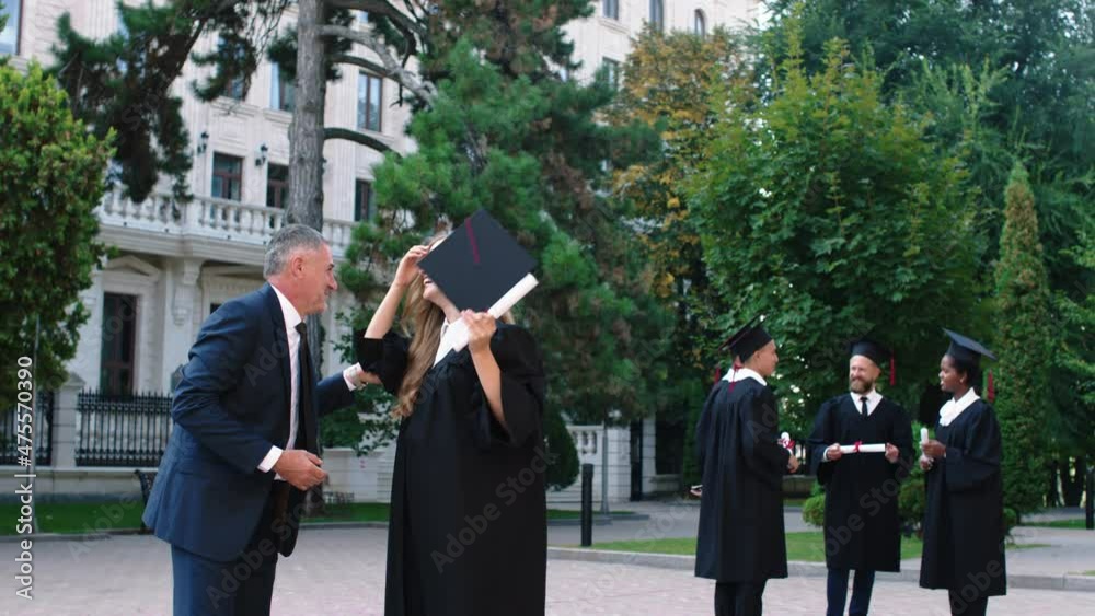 Graduation day in the college garden happy lady graduate running to her ...