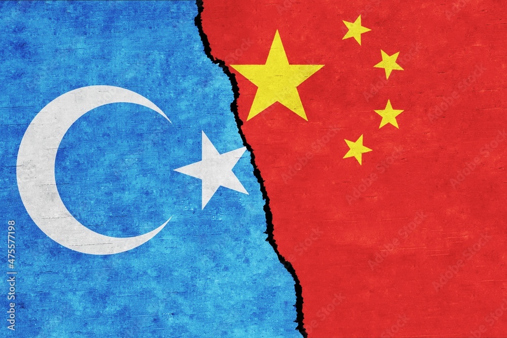 China and East Turkestan painted flags on a wall with a crack. China ...