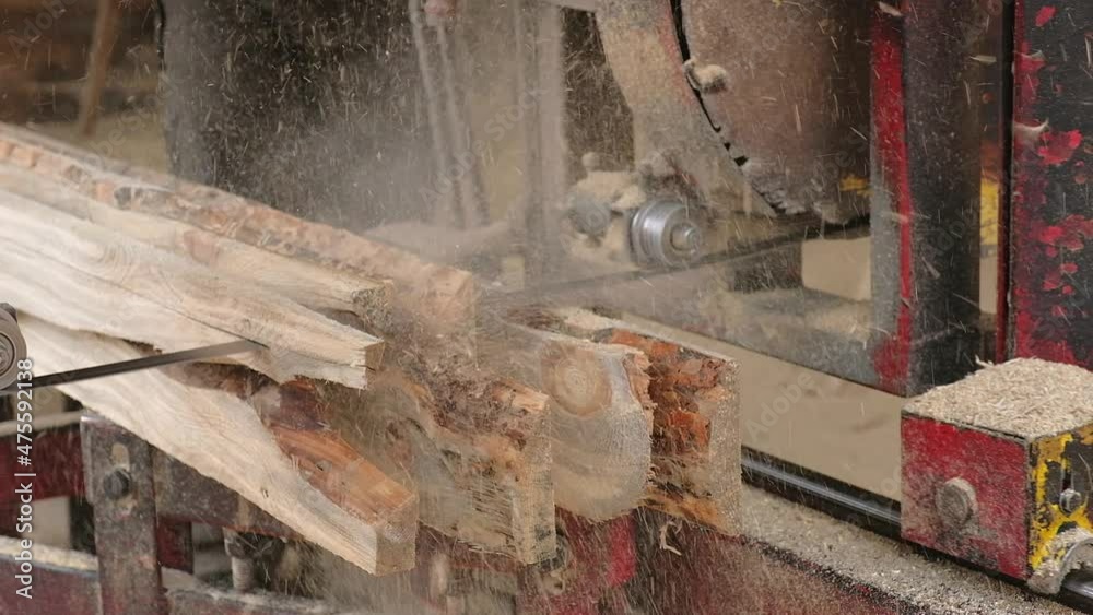 Sawing machine at a wood production plant. Processing and sawing timber ...