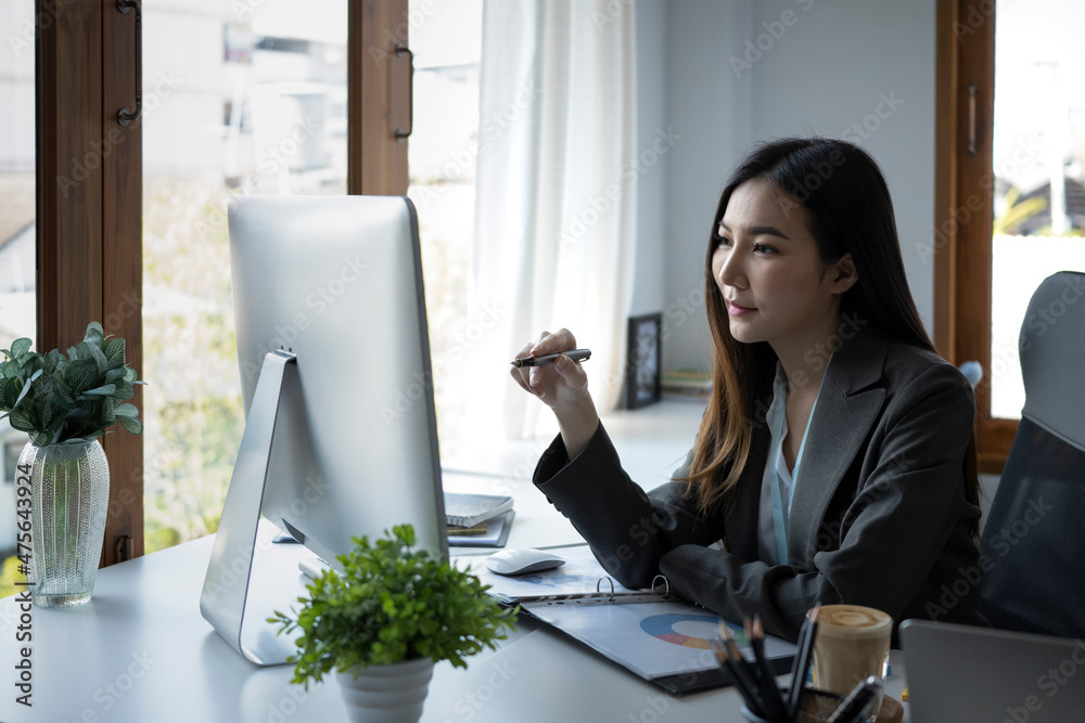 Beautiful asian woman entrepreneur working with computer in modern ...