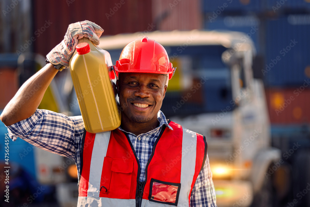 Maintenance man in the automotive industry holding engine oil. Stock ...