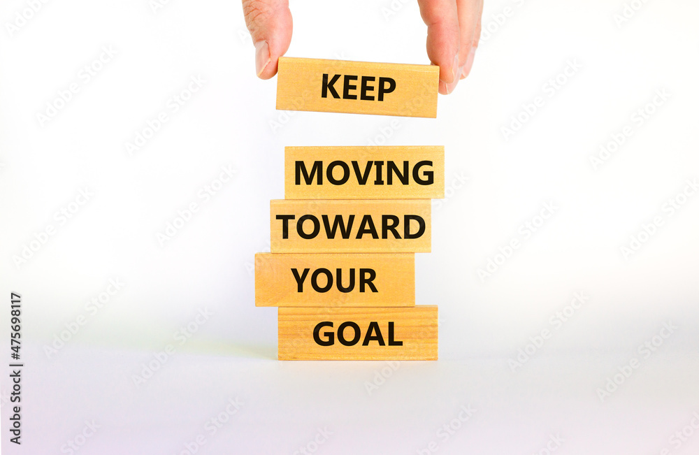Keep moving toward your goal symbol. Wooden blocks with words Keep ...