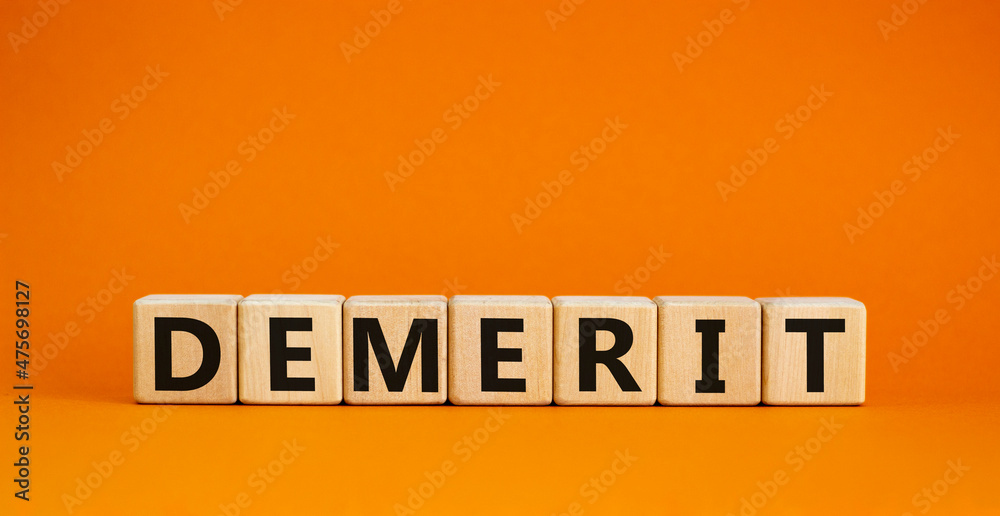 Demerit symbol. The concept word Demerit on wooden cubes. Beautiful ...