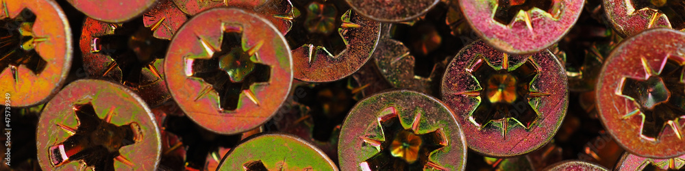Anodized screw caps close-up. A vivid banner on the theme of hardware ...