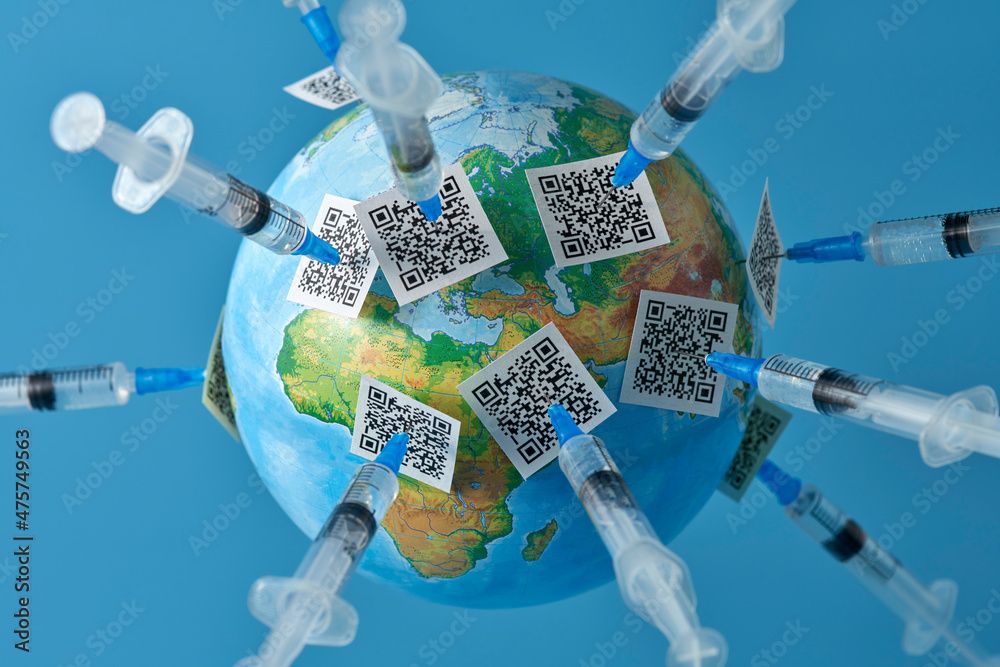 Planet earth close-up with lots of syringes and QR codes on a light ...