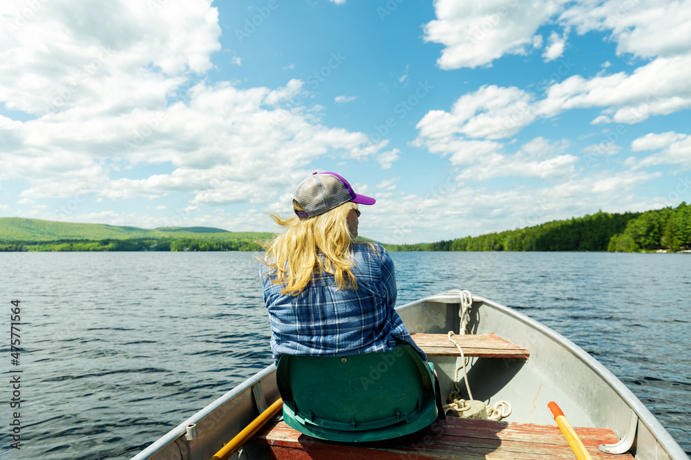 Woman on a boat with blonde hair blowing in the wind. Woman on a Maine ...