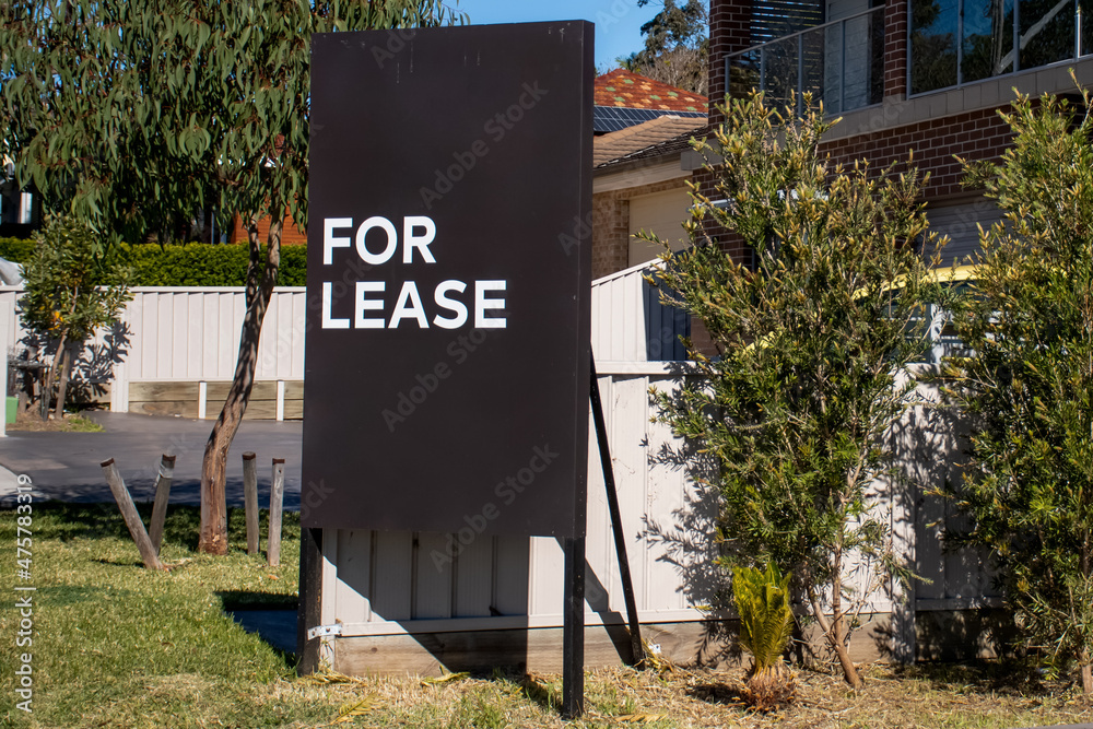 For lease sign on a black display outside of a resedential building in ...