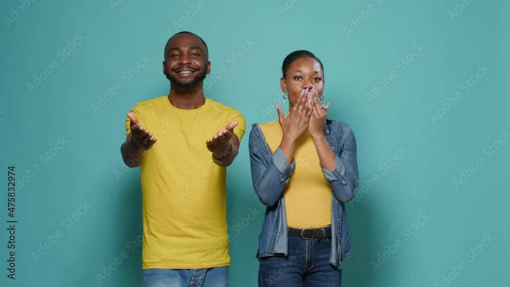 Romantic couple sending air kisses with hands together in front of ...
