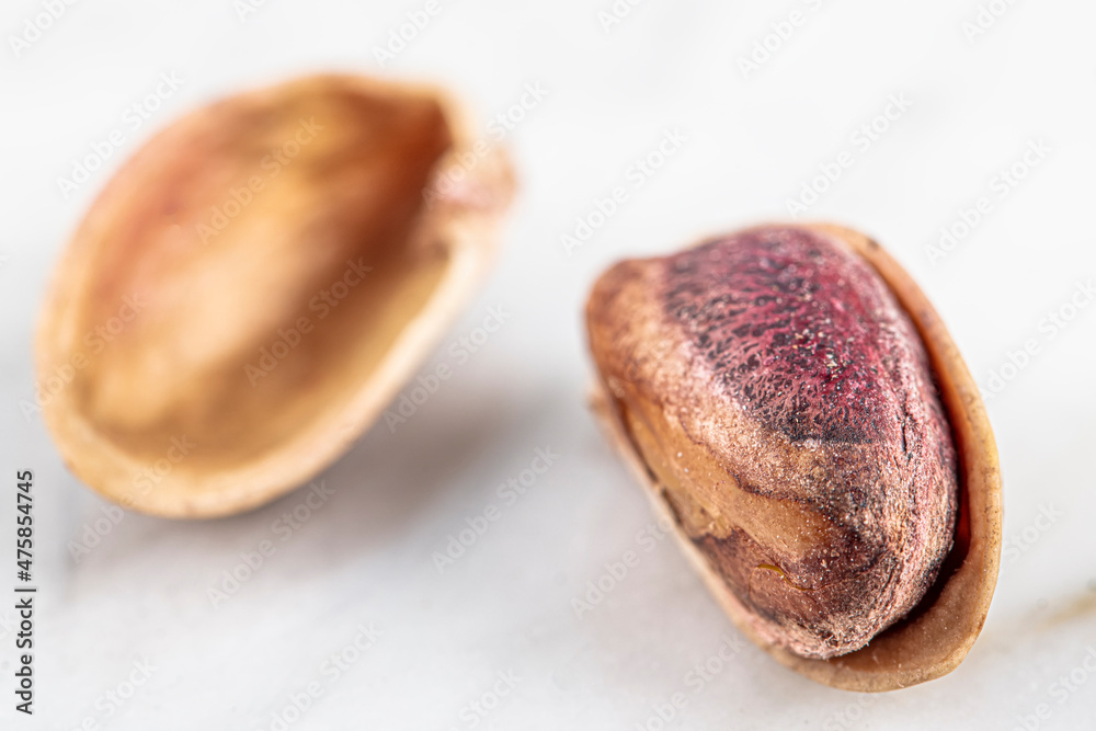 Pile of pistachios in the peel close-up. Pistachio isolated on marble ...