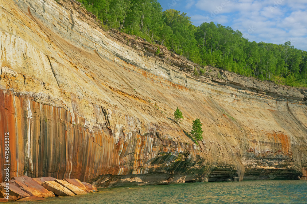 Landscape of the mineral stained, sandstone and eroded shoreline of ...