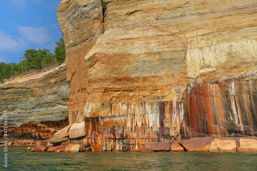 Landscape of the mineral stained, sandstone and eroded shoreline of ...