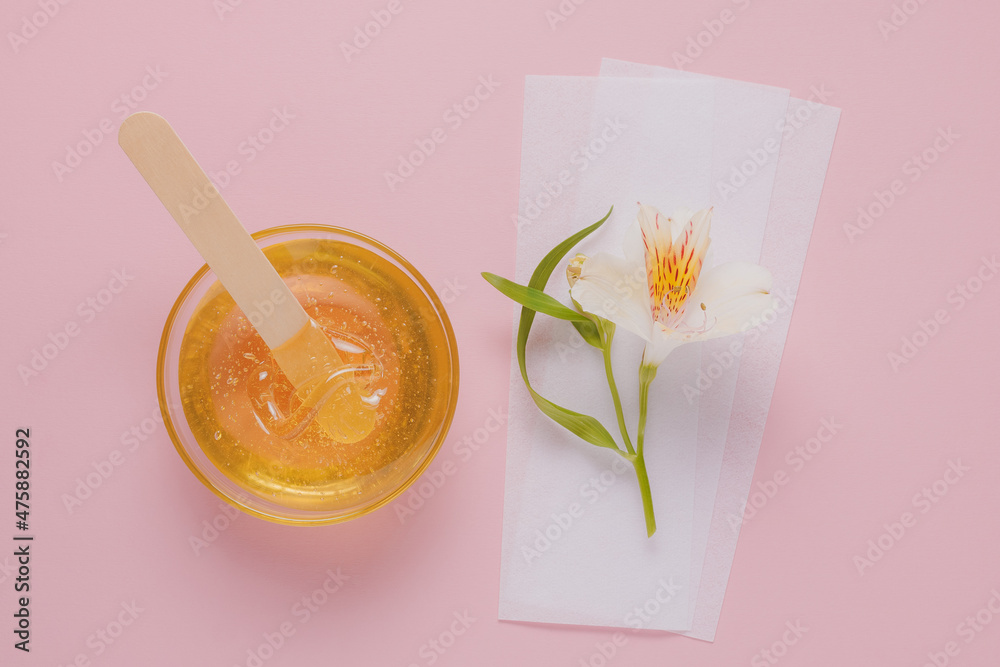 Liquid yellow sugar paste, wooden spatula, flower and depilatory strips ...