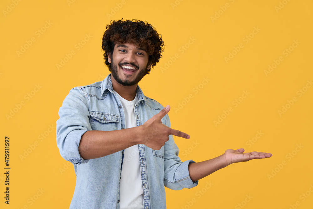 Excited happy positive young indian man student pointing aside with ...