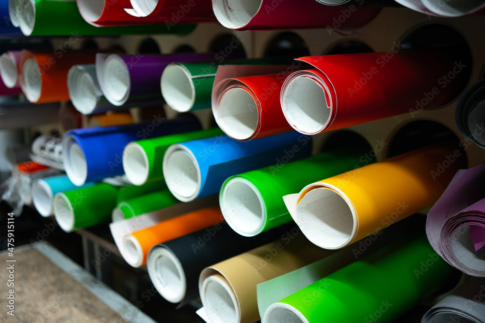 Tubes with multi-colored self-adhesive film on the shelf of the ...