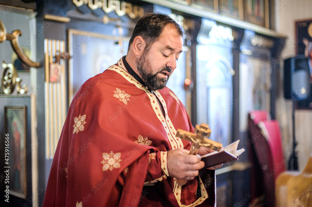 Religious priest holds holy Christian cross during religious chuch ...