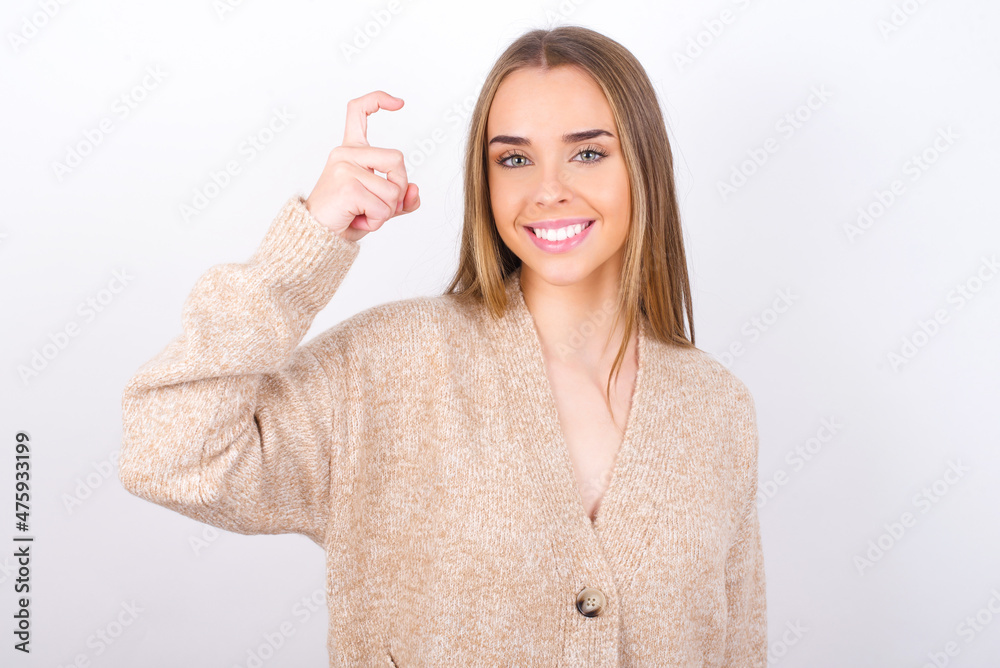 young caucasian girl wearing knitted sweater over white background ...