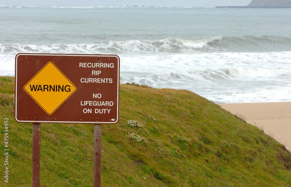 Rip currents warning sign by ocean. Stock Photo | Adobe Stock