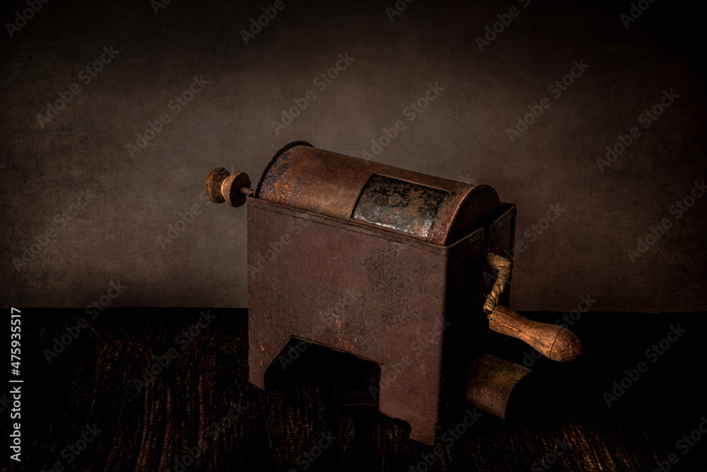 Still life with rustic rusty coffee roaster on vintage grunge ...