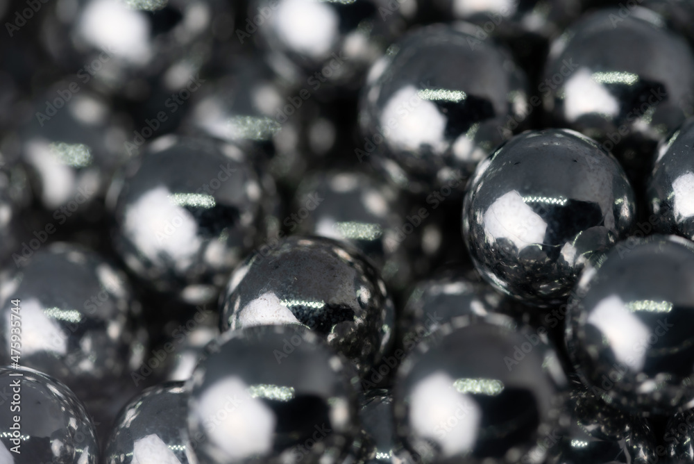 Metal balls arranged side by side to form an organized structure. Macro ...