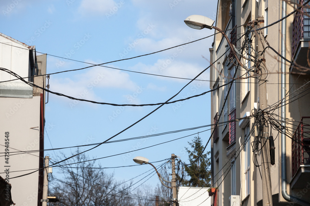 Messy cable management on a Old power electric line with a power supply ...