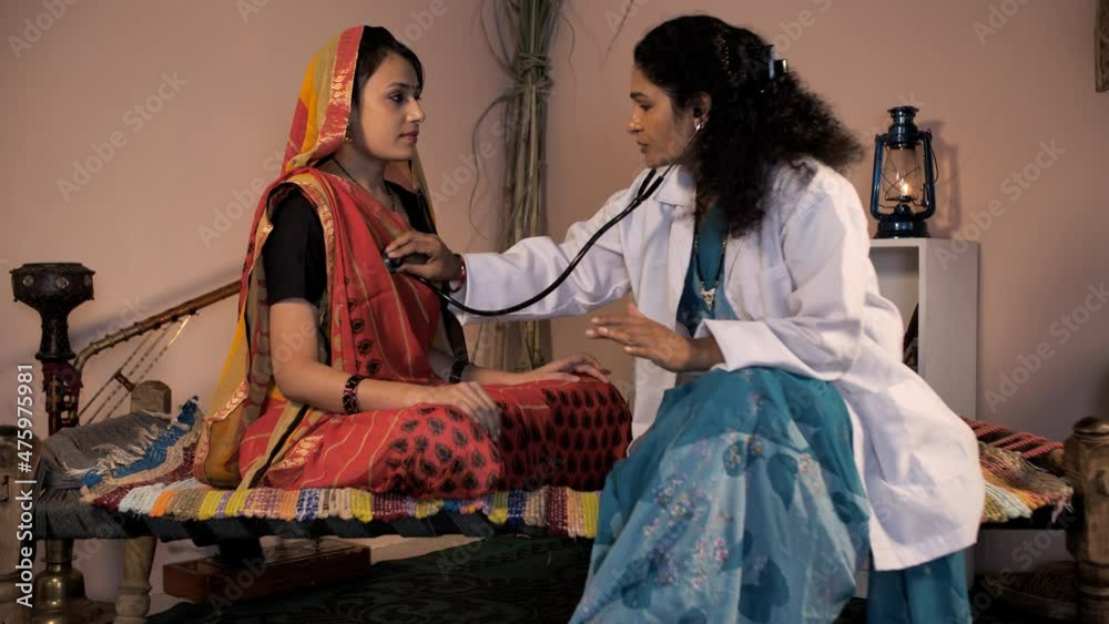 A female doctor examining a patient - Village home in India. Anganwadi ...