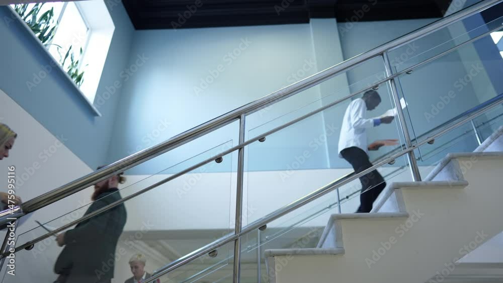 Side view office stairs with busy people walking up and down ...