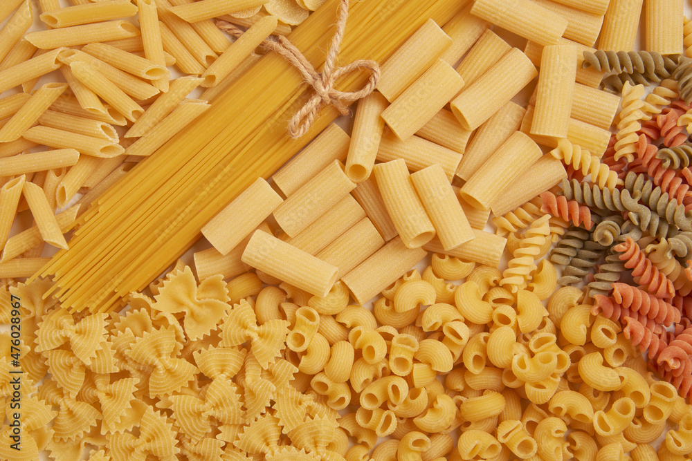 pasta concept various types of dry pasta being sorted into five groups ...
