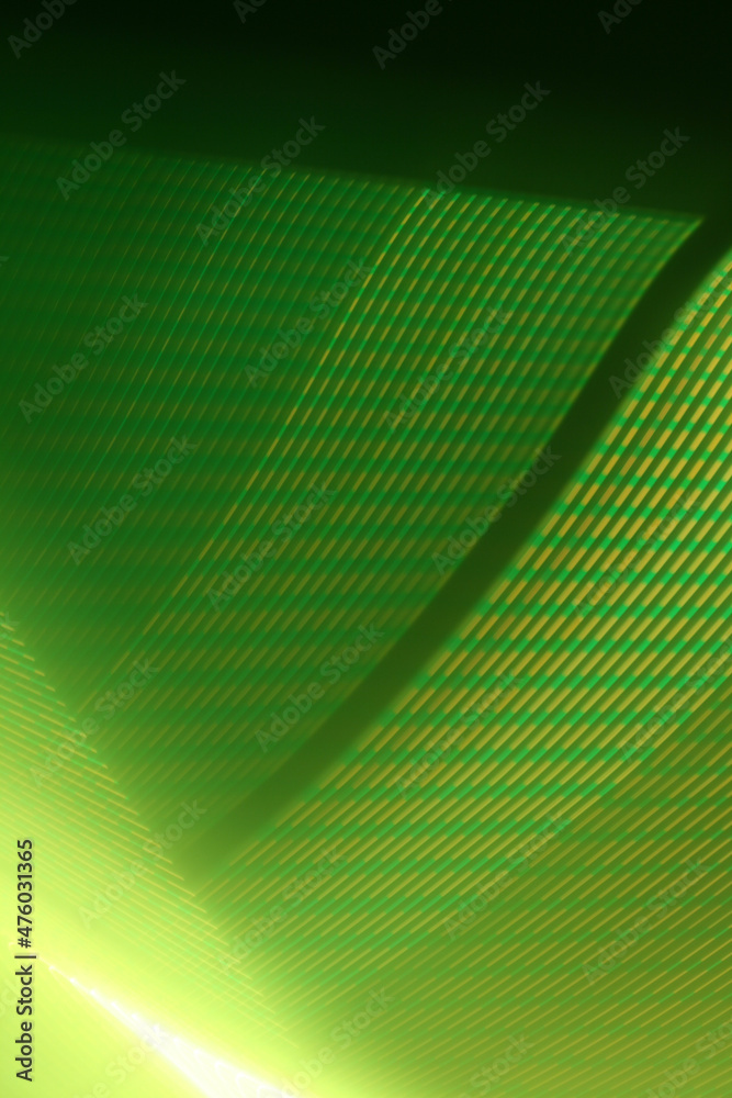 Futuristic texture of a green grid with wavy lines and gradient effect ...