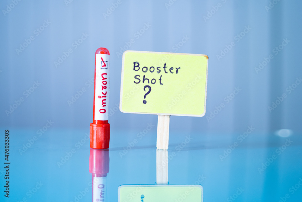 Booster shot question mark sign board placed next to positive Omicron ...