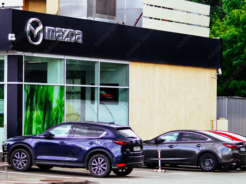 Kiev, Ukraine - July 08, 2020. Mazda sign and logo on the autosalon ...