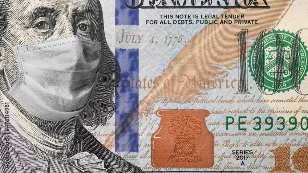 One hundred dollar bill with protective medical face mask on Benjamin ...