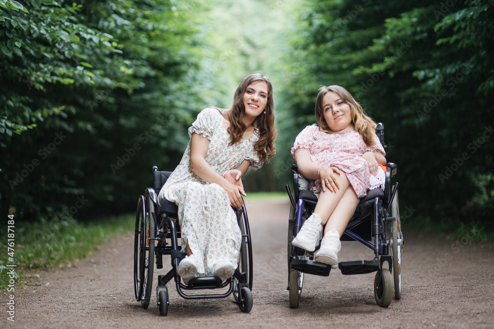 Happy young women with physical disability enjoying summer walk at ...