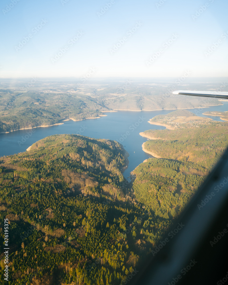 Beautiful aerial view of countryside during sunset from a Plane window ...