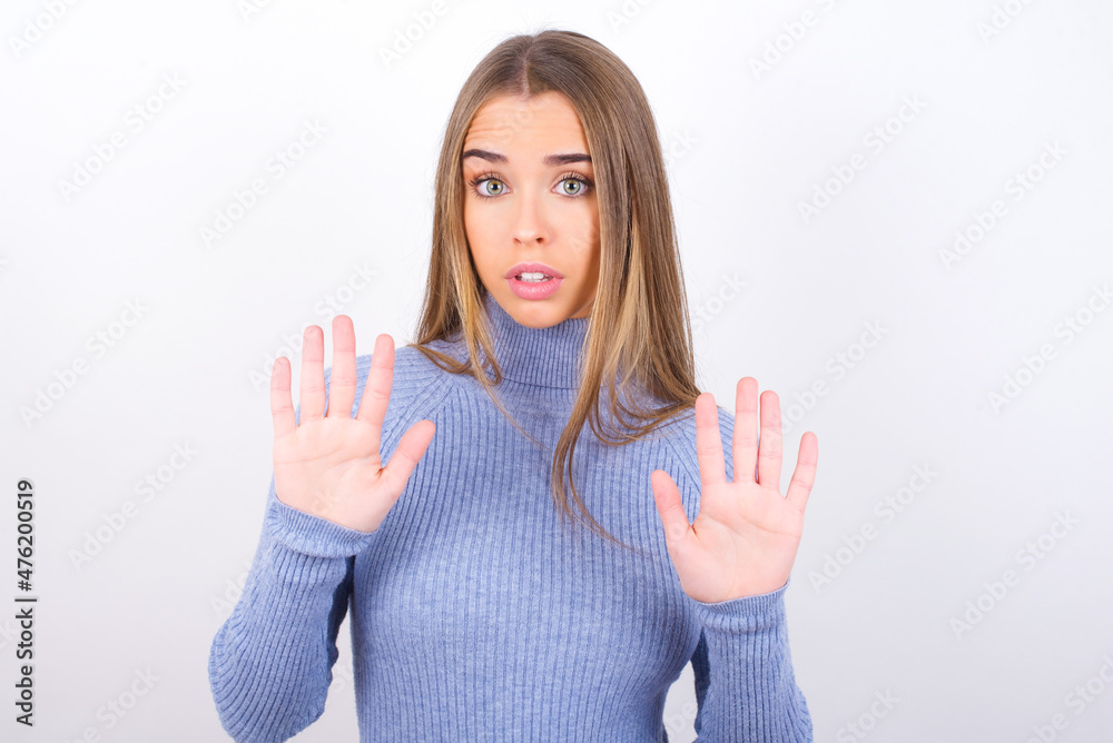 Young caucasian girl wearing blue turtleneck over white background ...