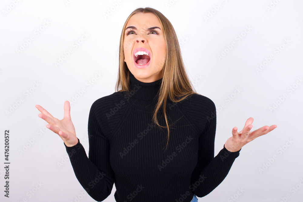 Young caucasian girl wearing black turtleneck over white background ...