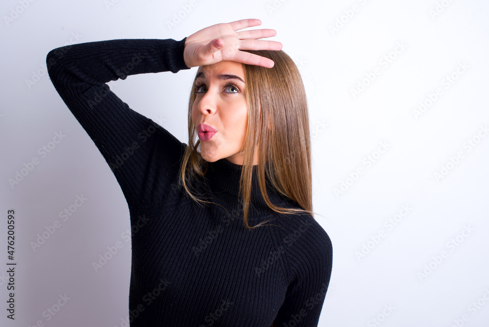Young caucasian girl wearing black turtleneck over white background ...